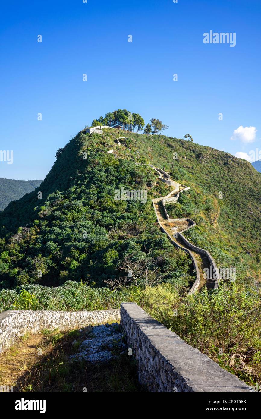 Curving path with dry stone wall leads over the mountains and hills at ...