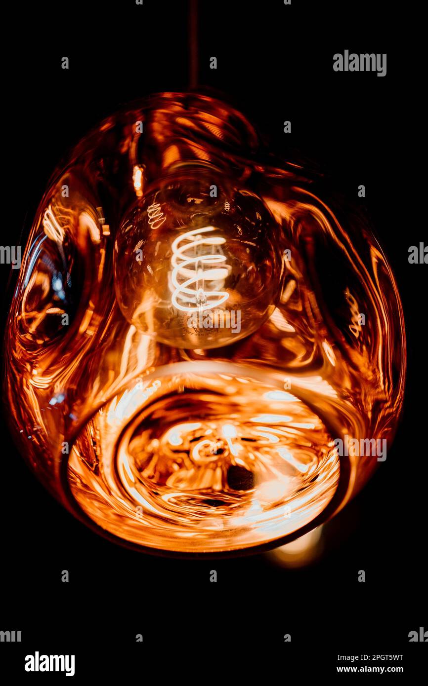 A single light source shining brightly in a dark room, creating a ...