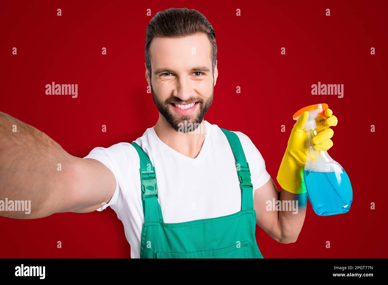 Self portrait of cheerful joyful cleaner with stubble in uniform ...