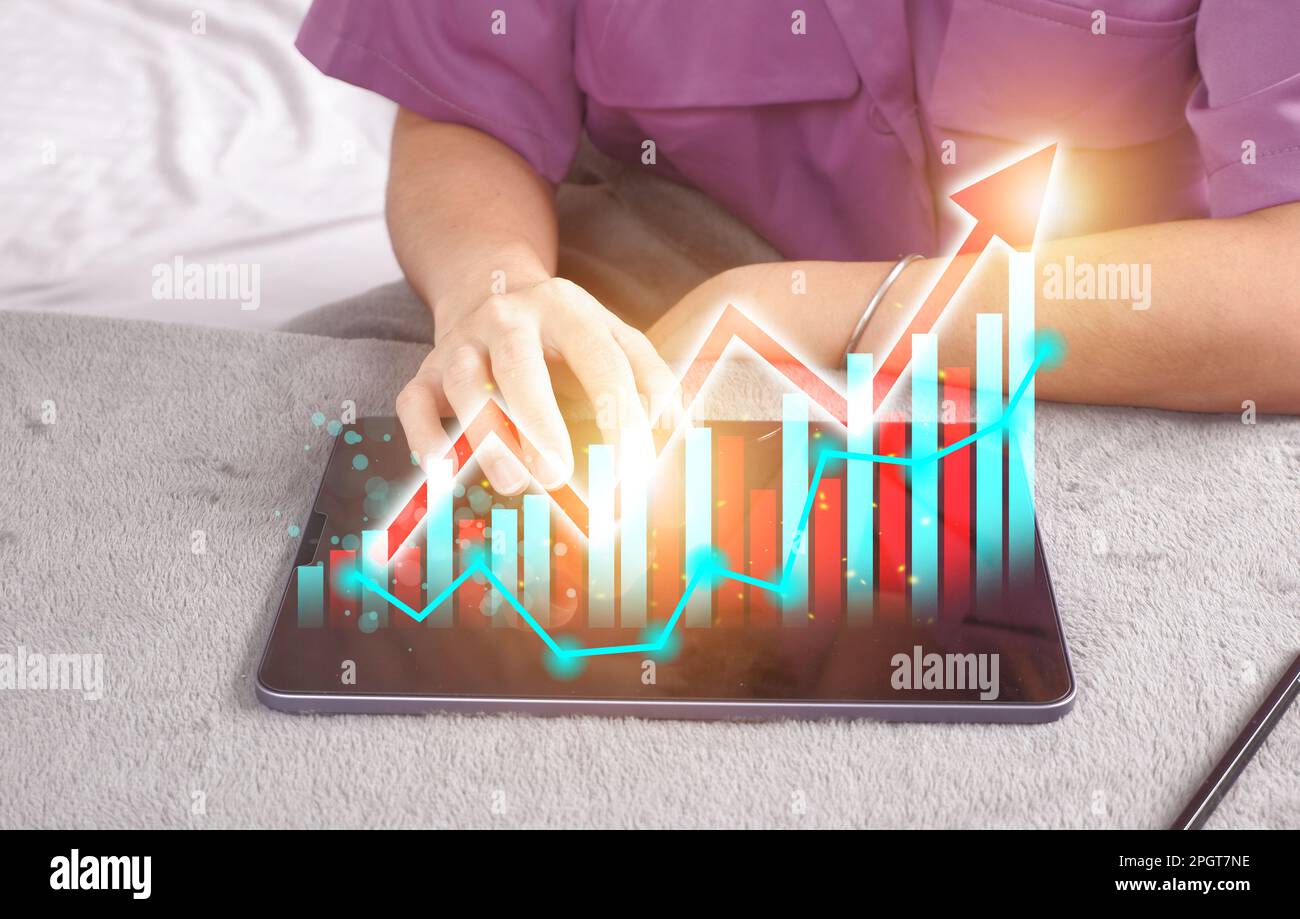 business growth plan with virtual hologram chart Calculate earnings and ...