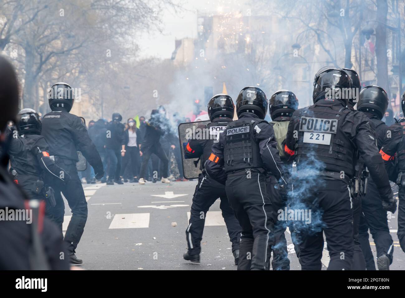 French riot police ( Brav ) facing rioters in the smoke of tear gas at ...