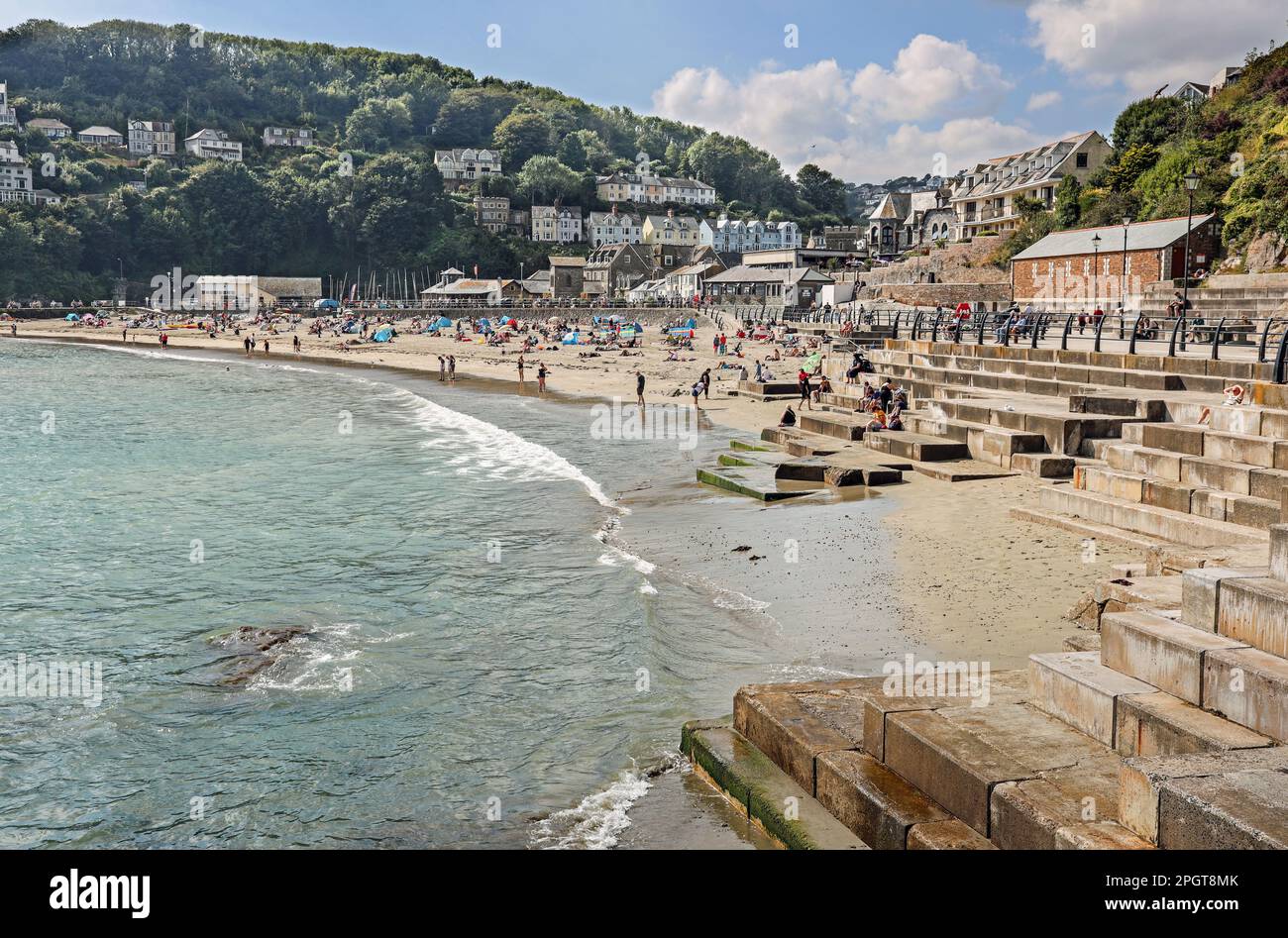 Late season at the beach in East Looe, Cornwall, in the background West ...