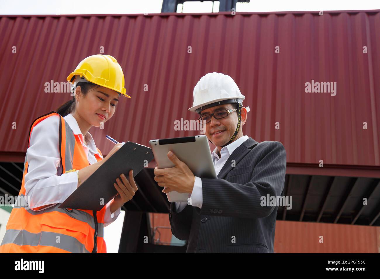 Warehouse business manager and port worker working and checking ...