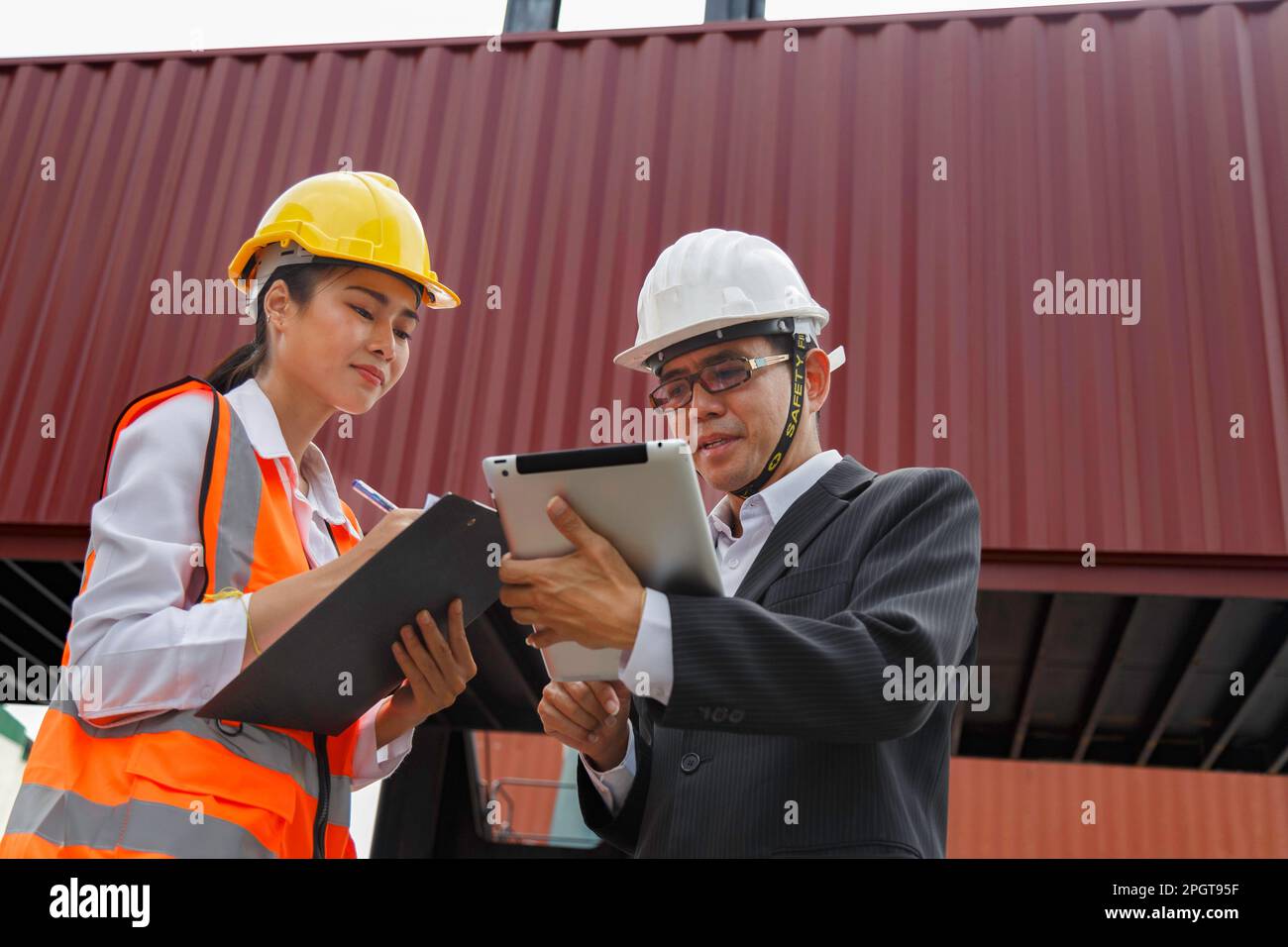 Warehouse business manager and port worker working and checking ...