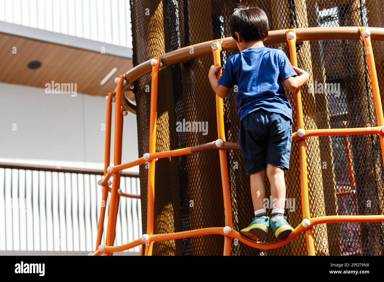 happy asian boy play on playground. boy kid climbing up on ladder at ...