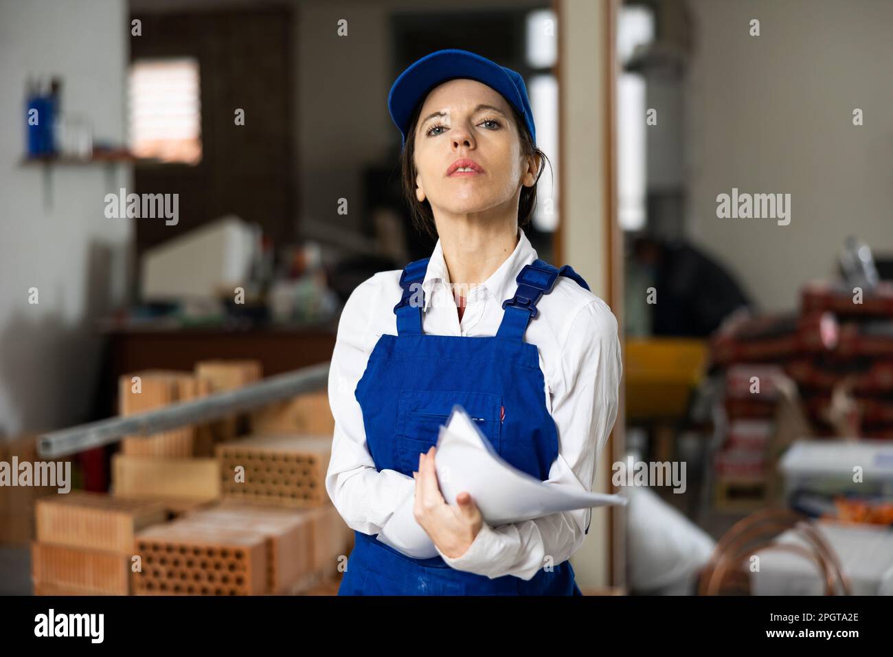 Female contractor taking notes while planning building renovation Stock ...