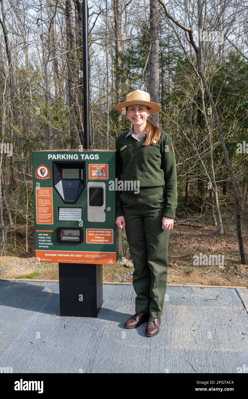 Female National Park Ranger next to a automated machine that dispenses ...