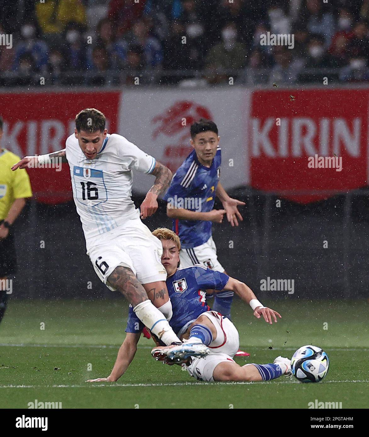 Uruguay's Mathias Olivera (L) and Japan's DOAN Ritsu struggle to hold a ...