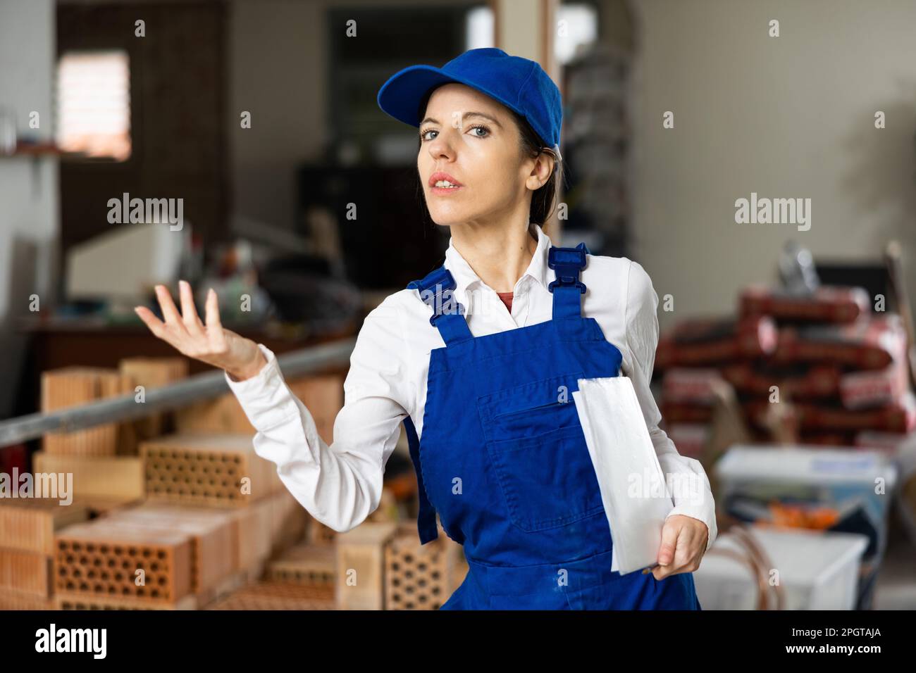 Female contractor showing customer amount of work done at construction ...
