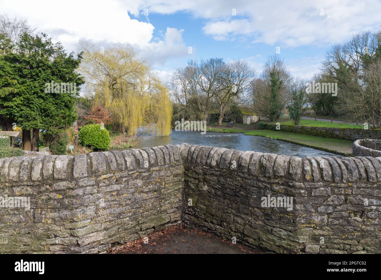 Old stone bridge over there River Wye in the pretty Derbyshire village ...