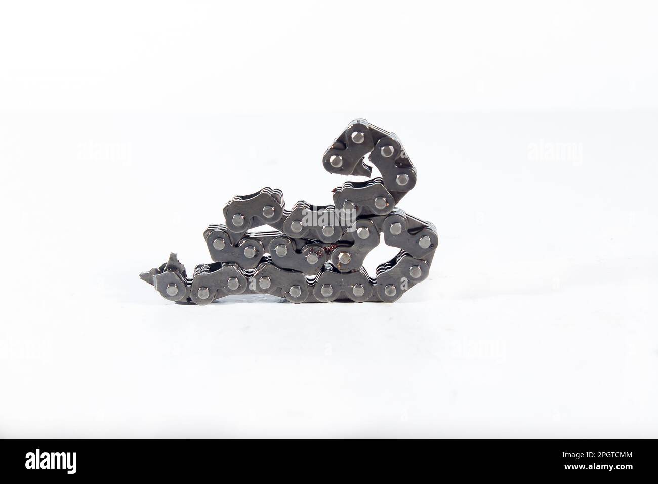Old chains inside the motorcycle engine on a white background ...