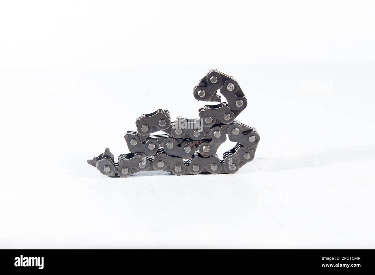 Old chains inside the motorcycle engine on a white background ...