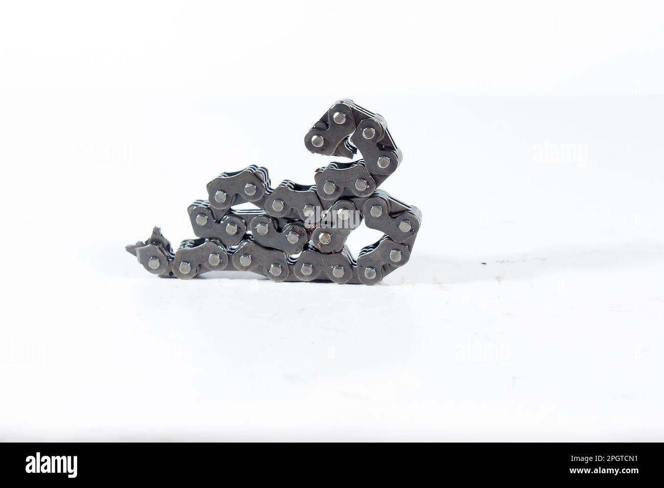 Old chains inside the motorcycle engine on a white background ...