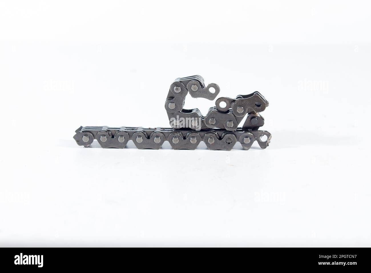 Old chains inside the motorcycle engine on a white background ...