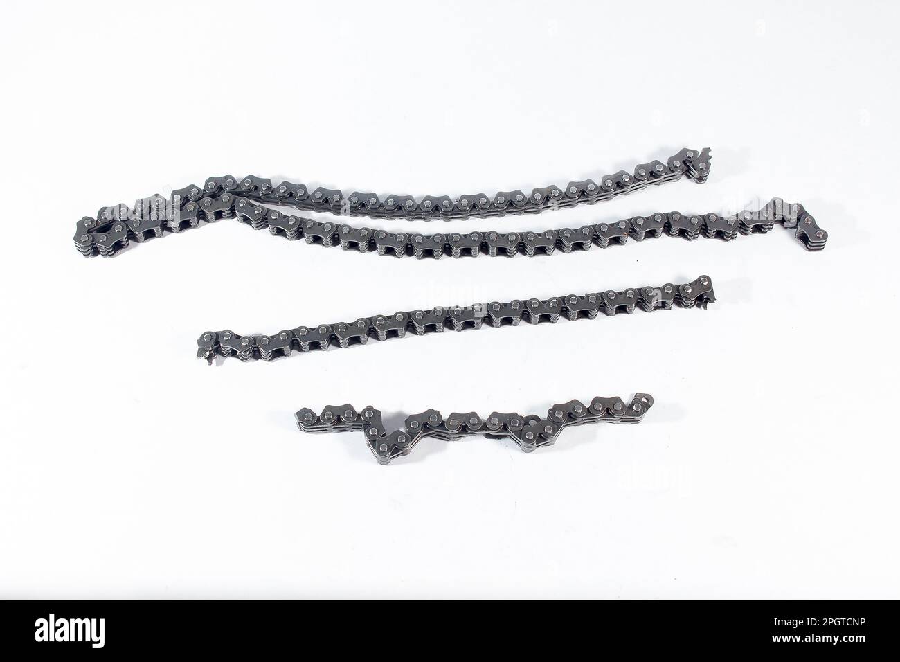 Old chains inside the motorcycle engine on a white background ...
