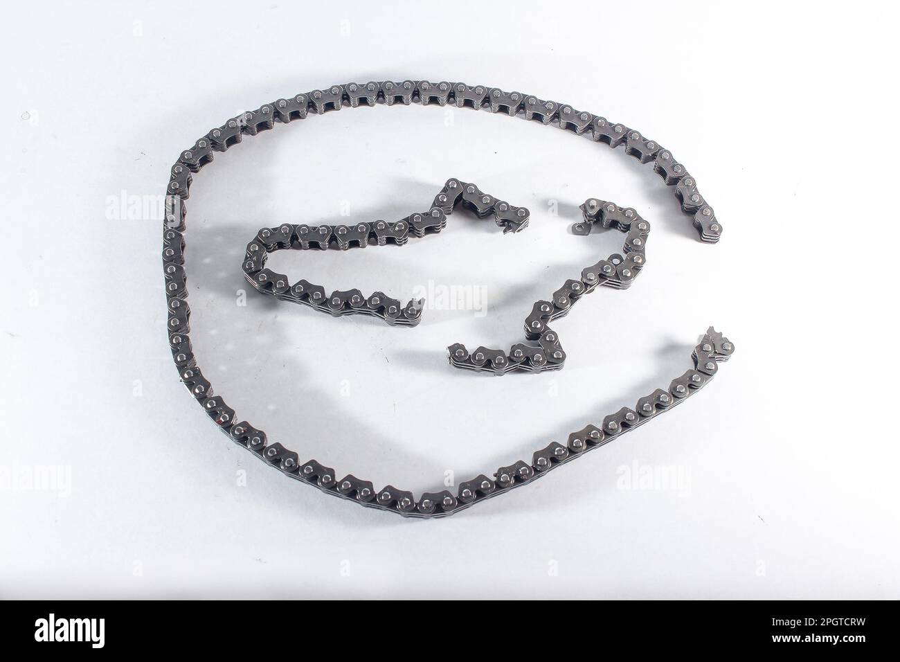 Old chains inside the motorcycle engine on a white background ...