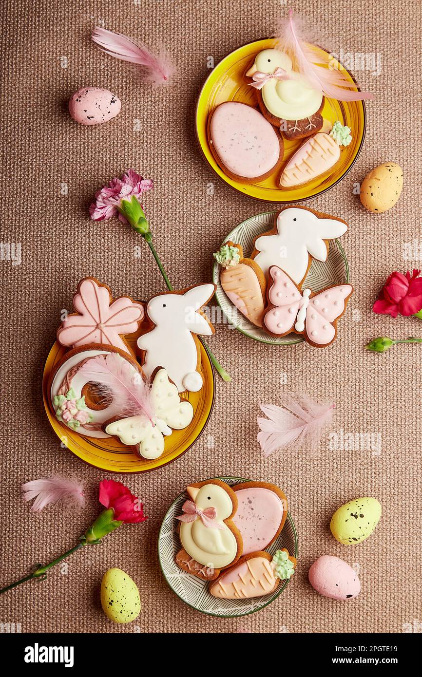 Decorated aesthetic Easter cookies, pink flowers with feathers and eggs ...