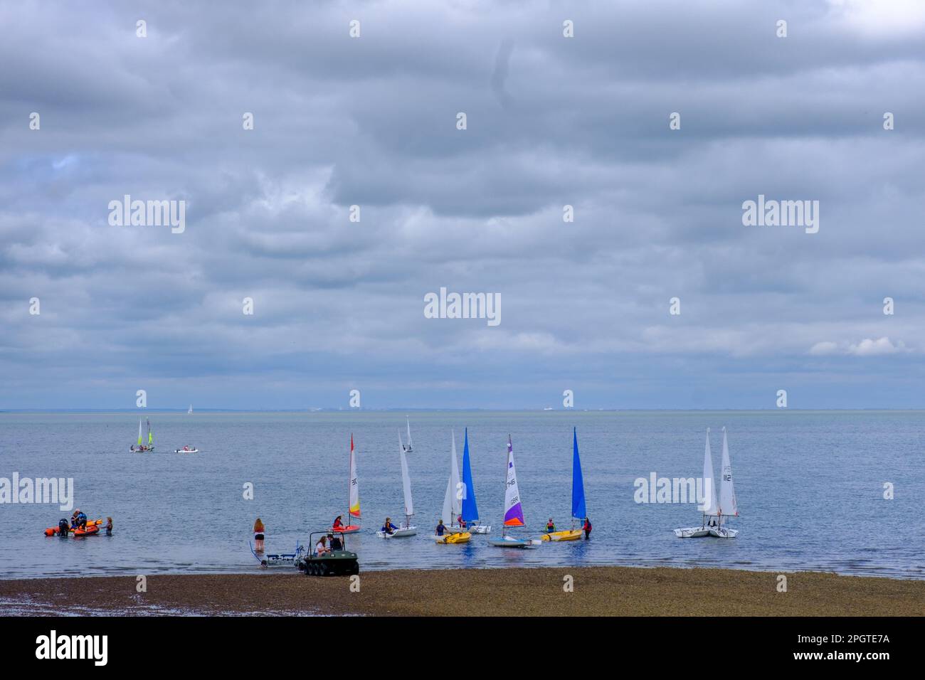 Sailing boats lined up in the water at Whitstable West Beach, north ...