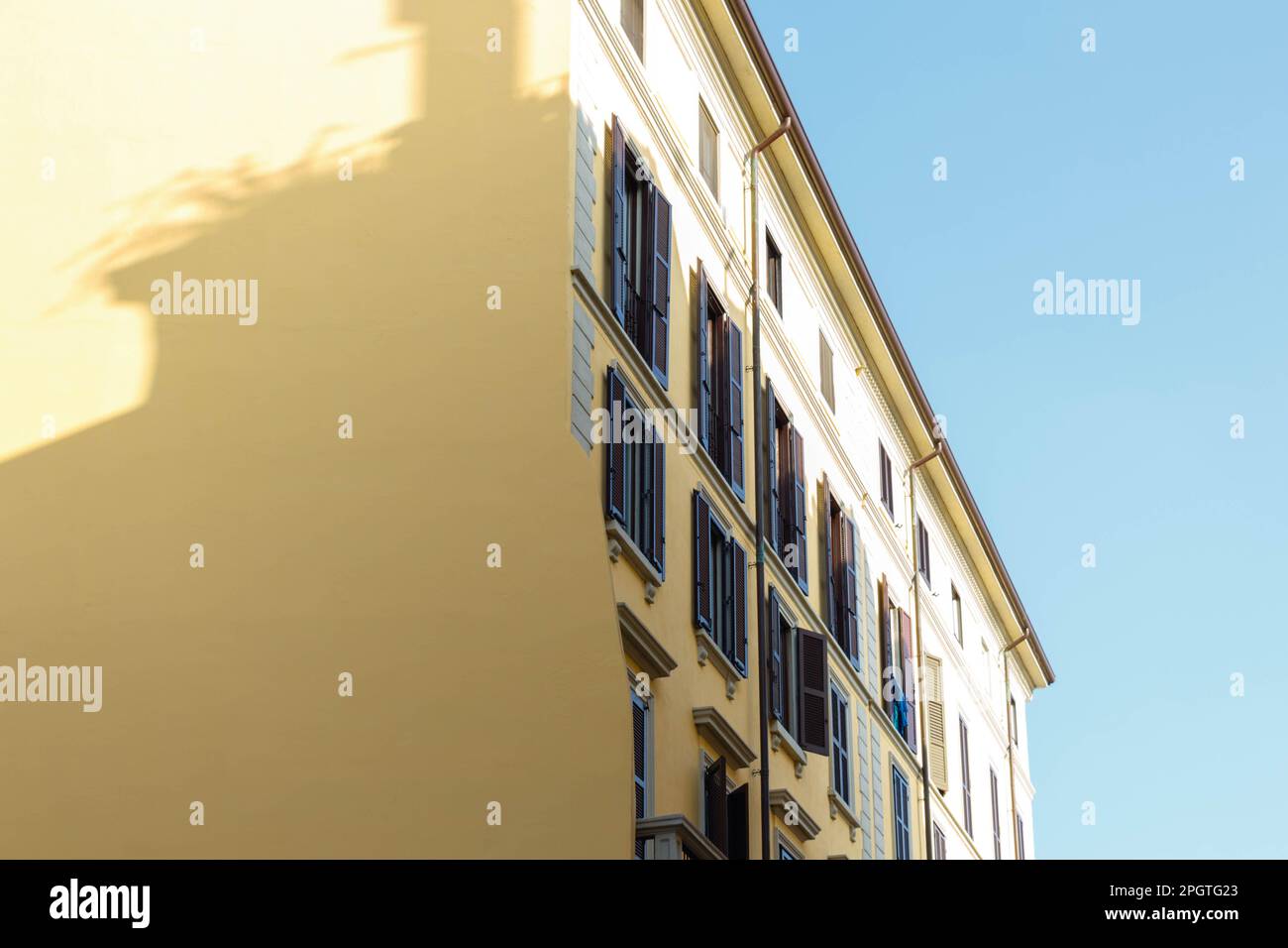 Yellow house building against a blue sky background Stock Photo - Alamy