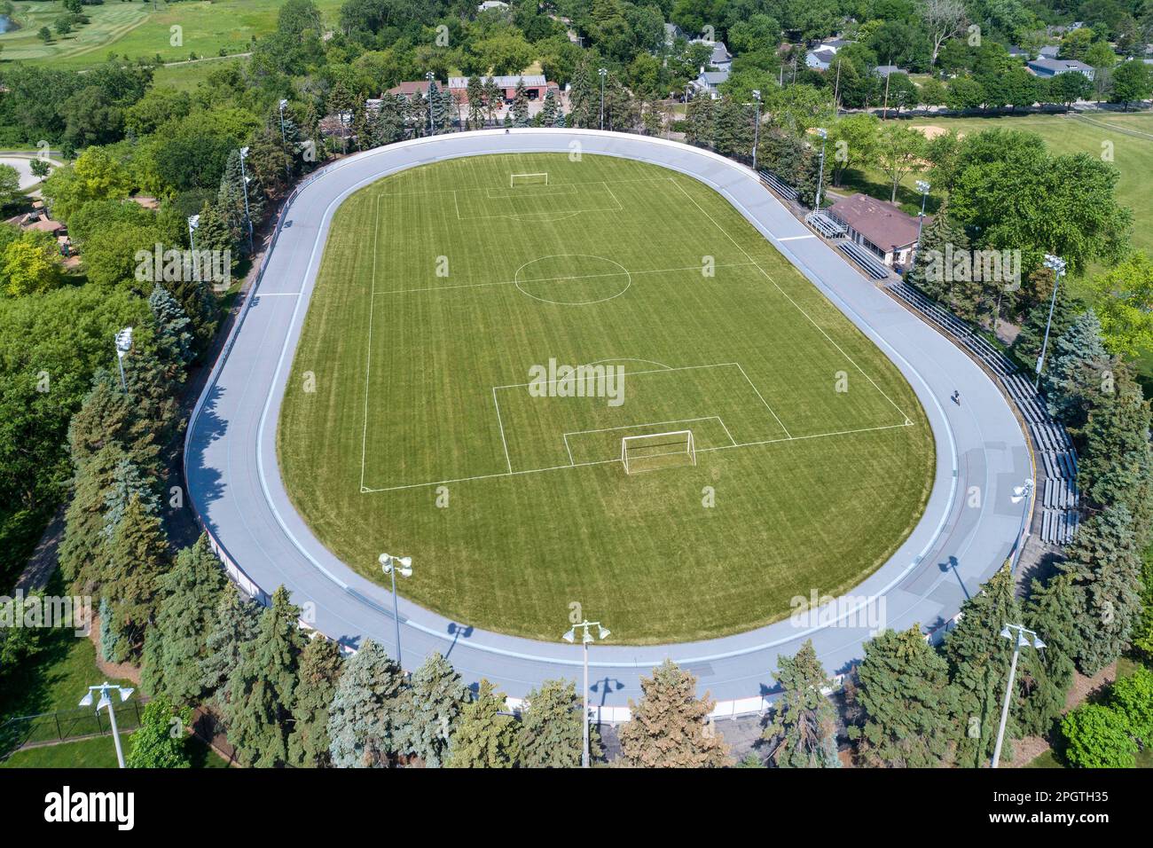 Aerial view of a lone cyclist training on a bike velodrome track near a ...