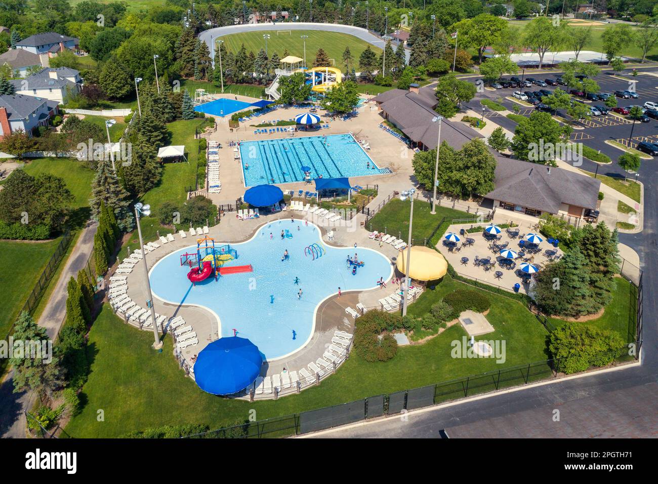 Aerial view of a large park with a public swimming pool and a velodrome ...