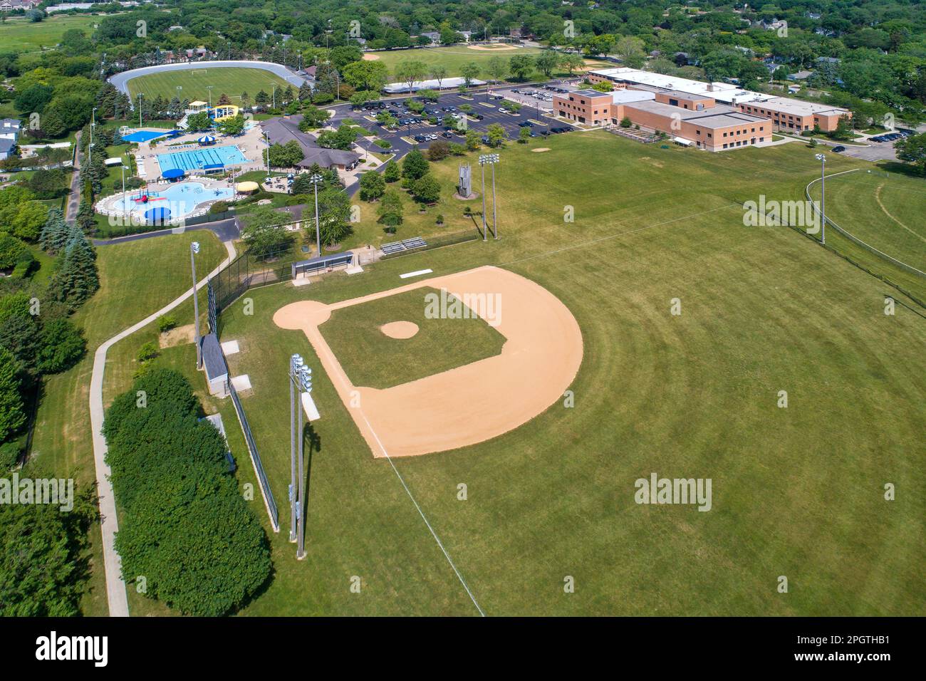 Aerial view of a large park with a junior high school, baseball diamond ...