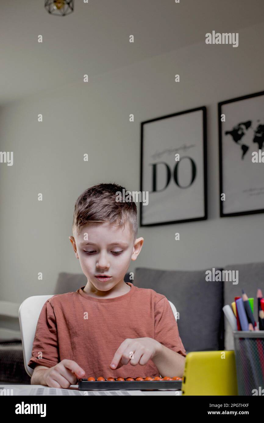 Little boy counting with the help of mental arithmetic. Mathematics in ...