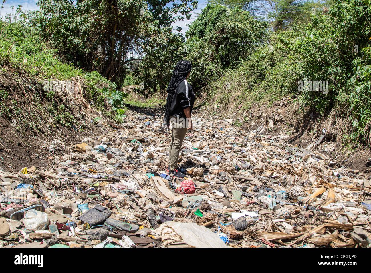 Nakuru, Kenya. 23rd Mar, 2023. A woman stands on a dry river bed ...