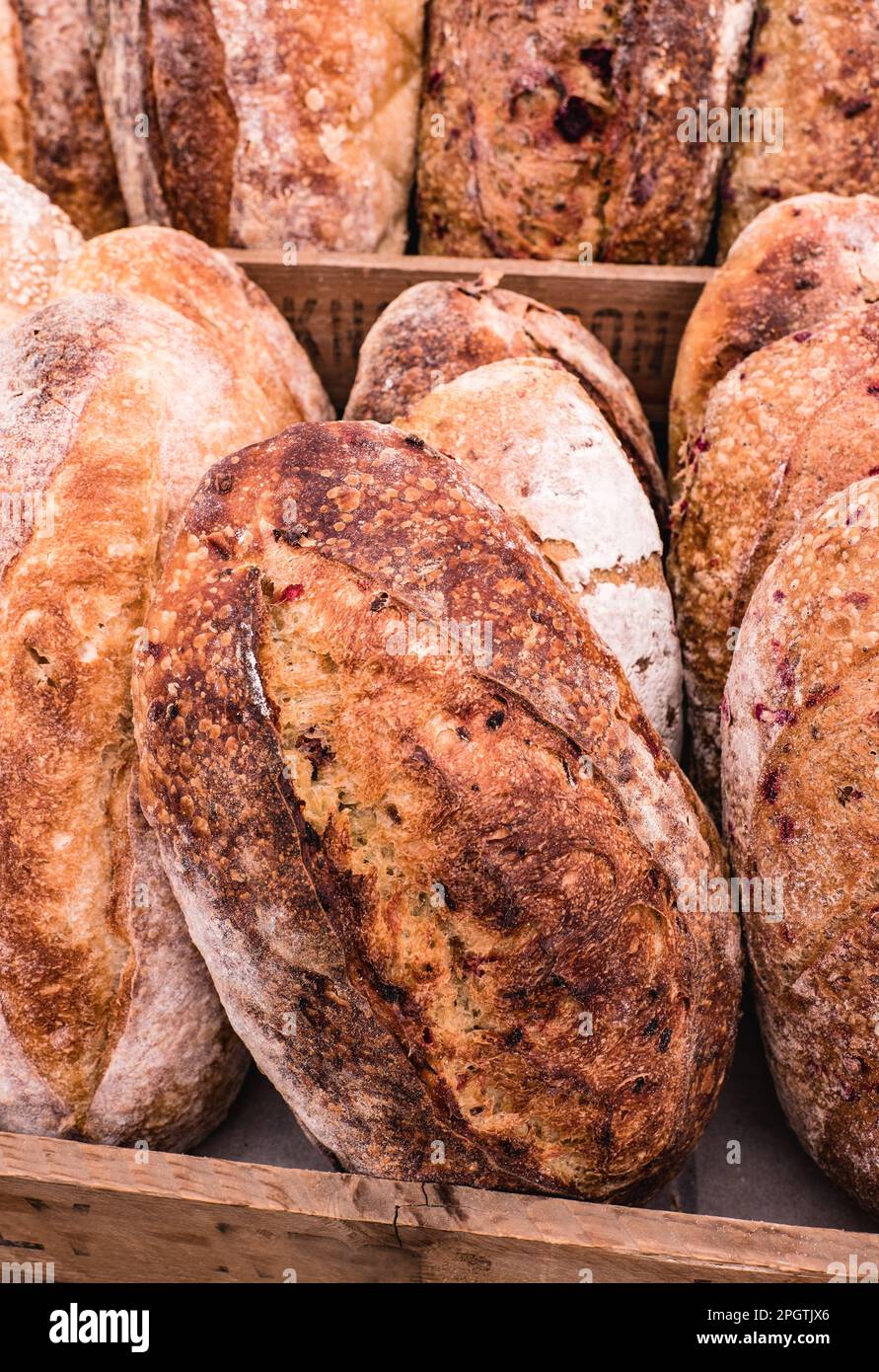 A vertical shot of fresh loaves of bread on the racks of a market Stock ...