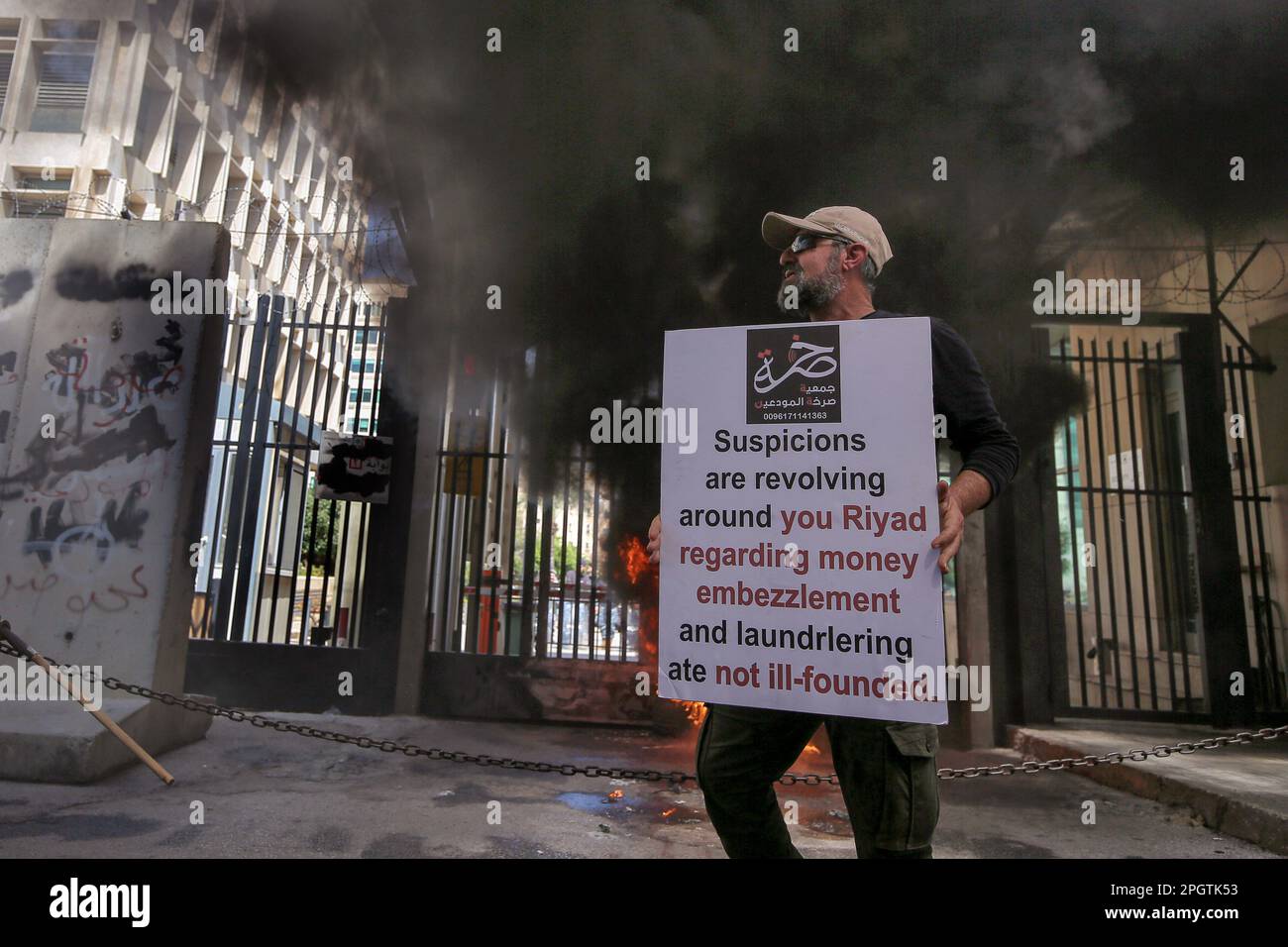 24 March 2023, Lebanon, Beirut: A protest holds a banner in front of ...