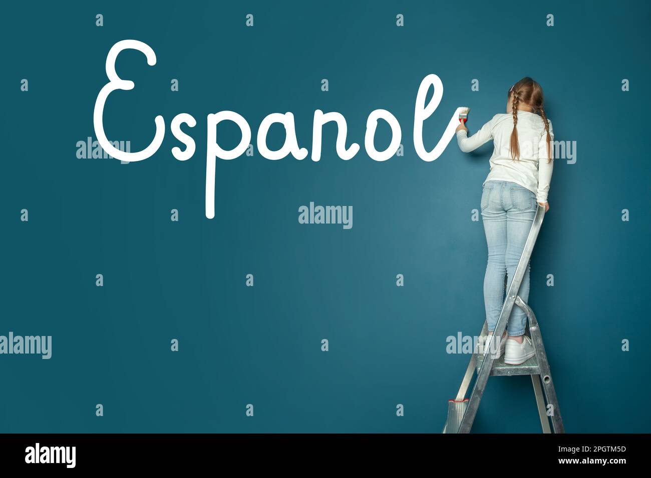 Child student girl standing on ladder and writin Spanish language on ...