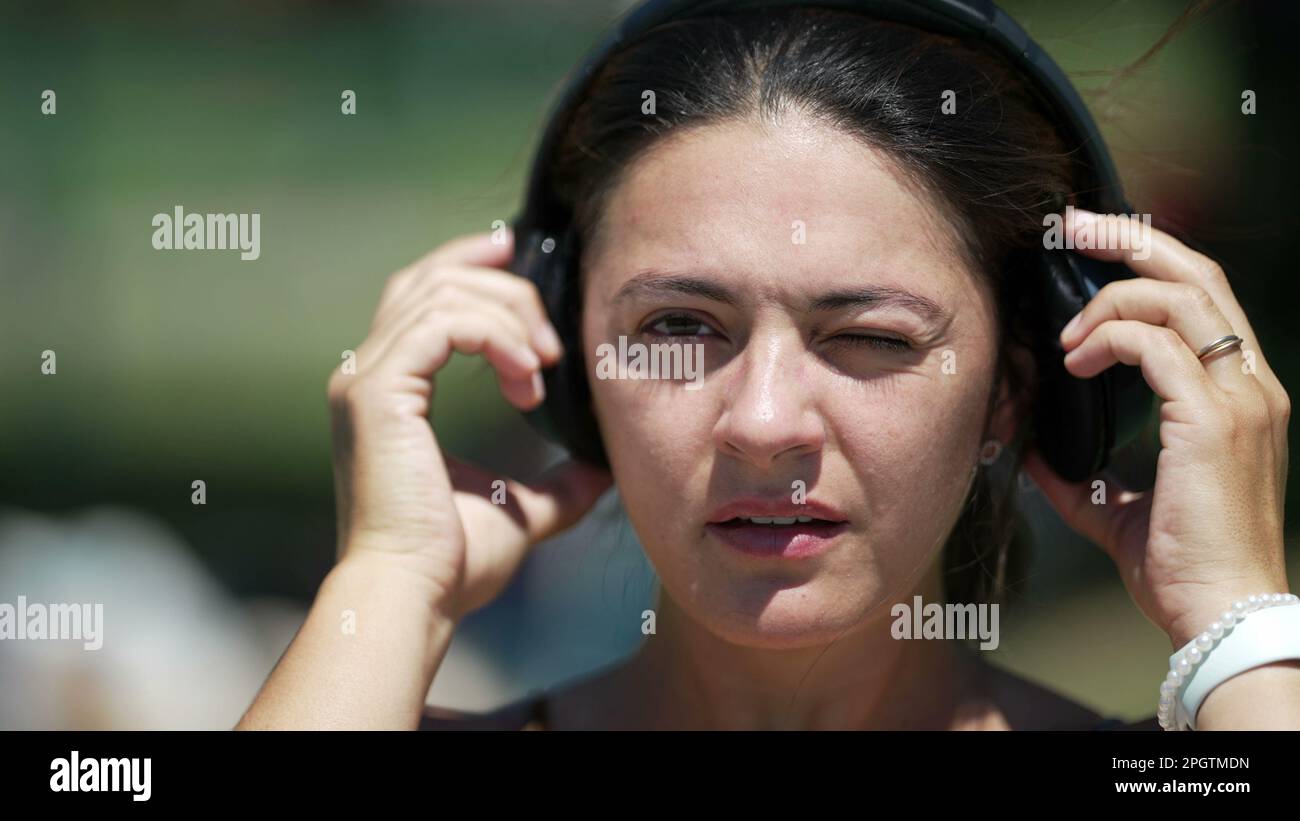 Woman takes off headphones hi-res stock photography and images - Alamy
