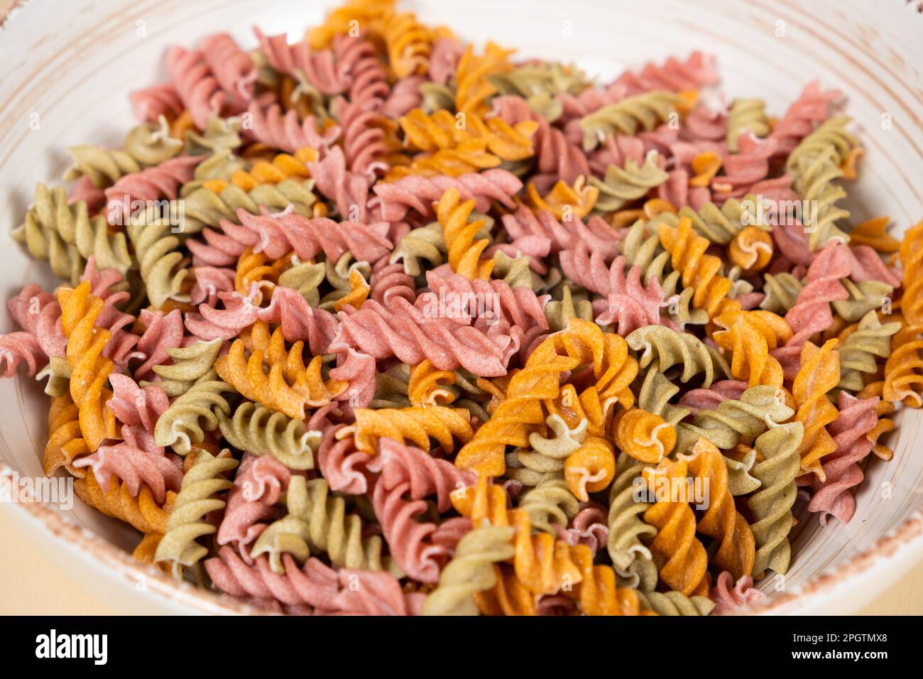 Rice vegetable pasta in the form of spirals in a bowl. Healthy rice ...