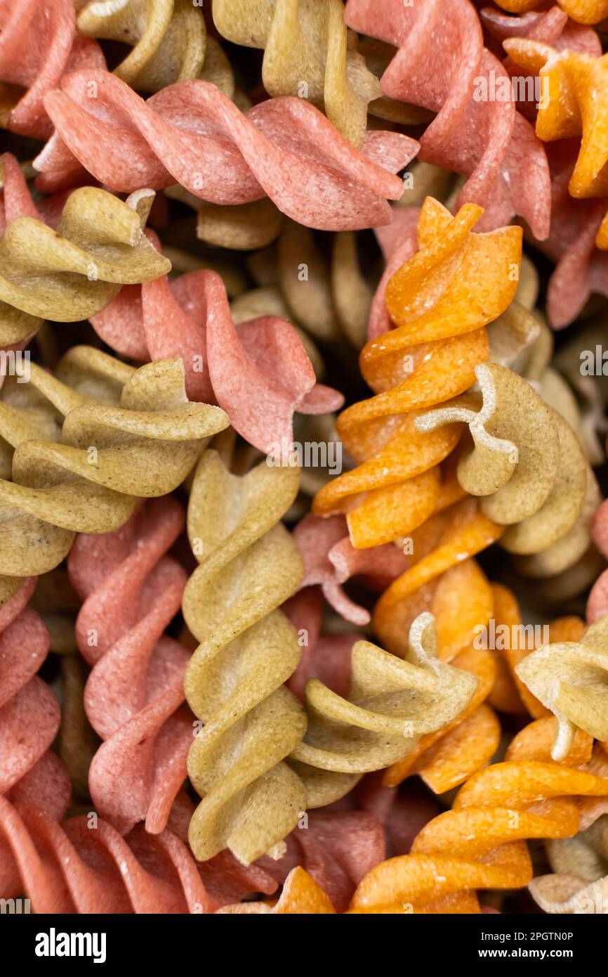 Rice vegetable pasta in the form of spirals, top view. Healthy rice ...