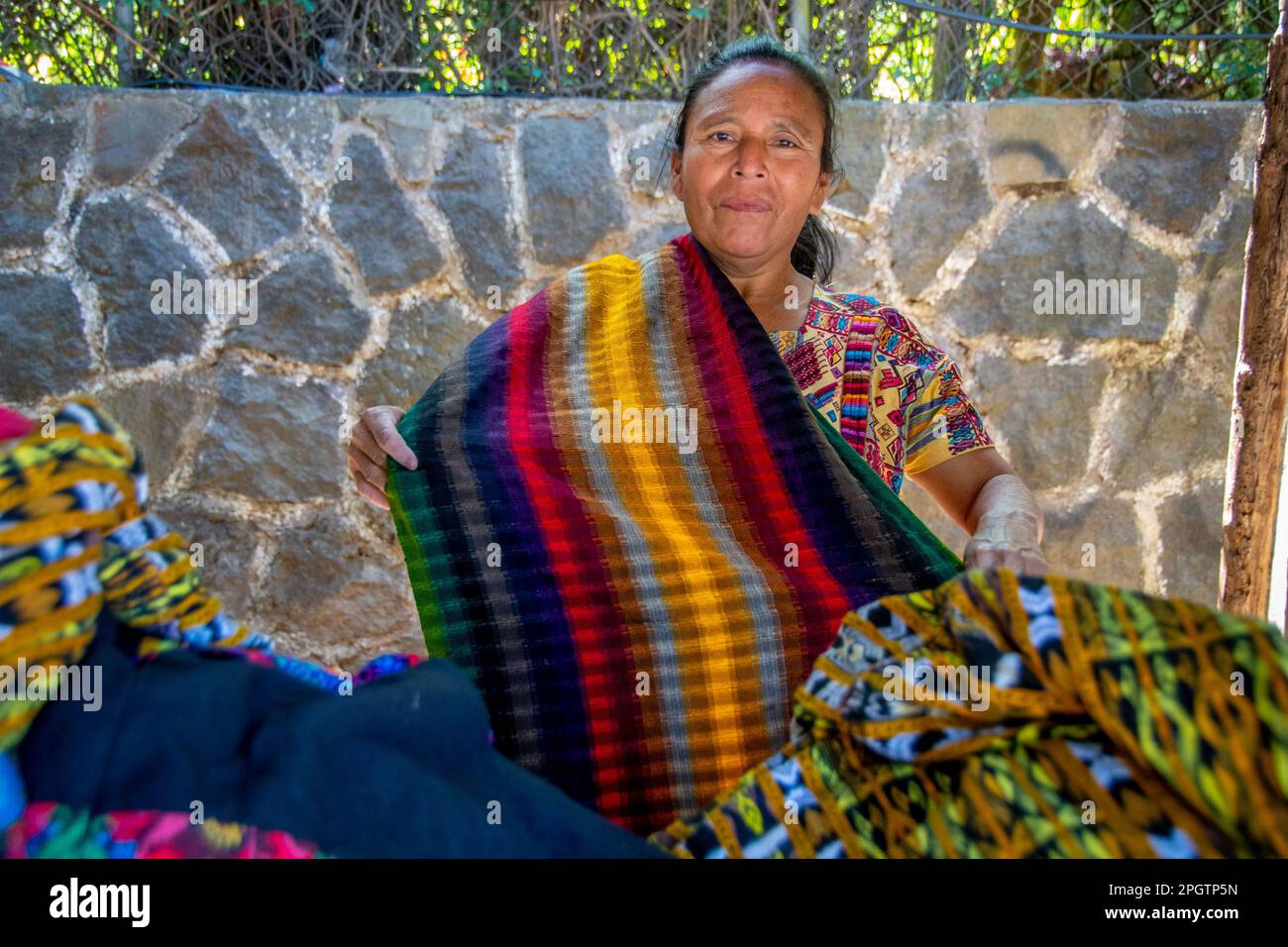 Mayan woman holding handmade textile in Panajachel Guatemala Stock ...