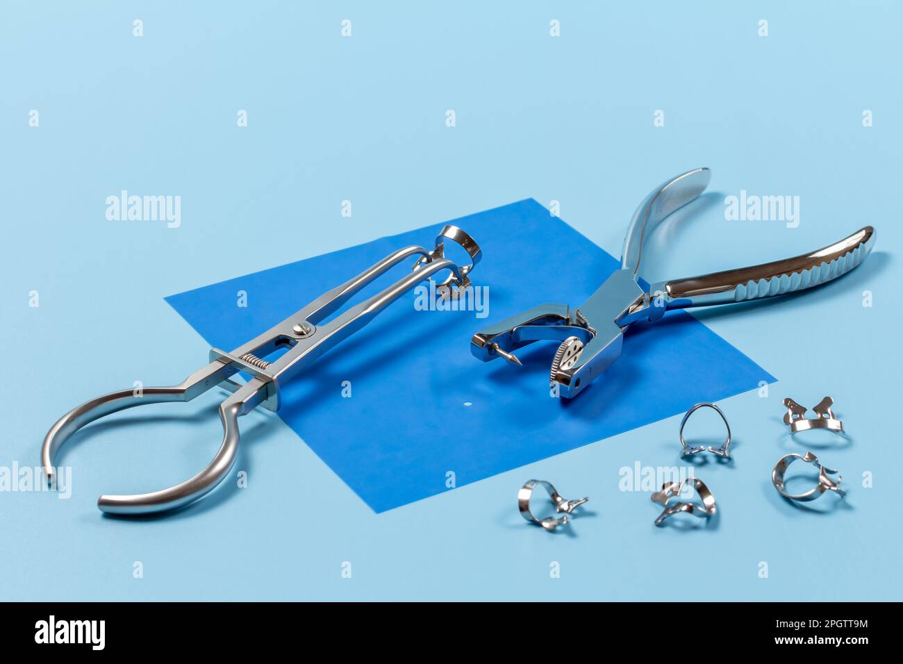 Dental hole punch, the clamps and the rubber dam forceps Stock Photo ...