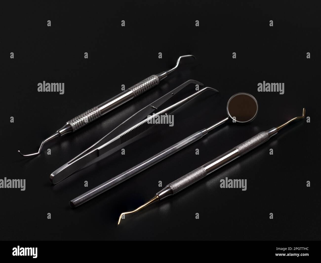 Mouth mirror, tweezers, a dental restoration instrument and a curette ...