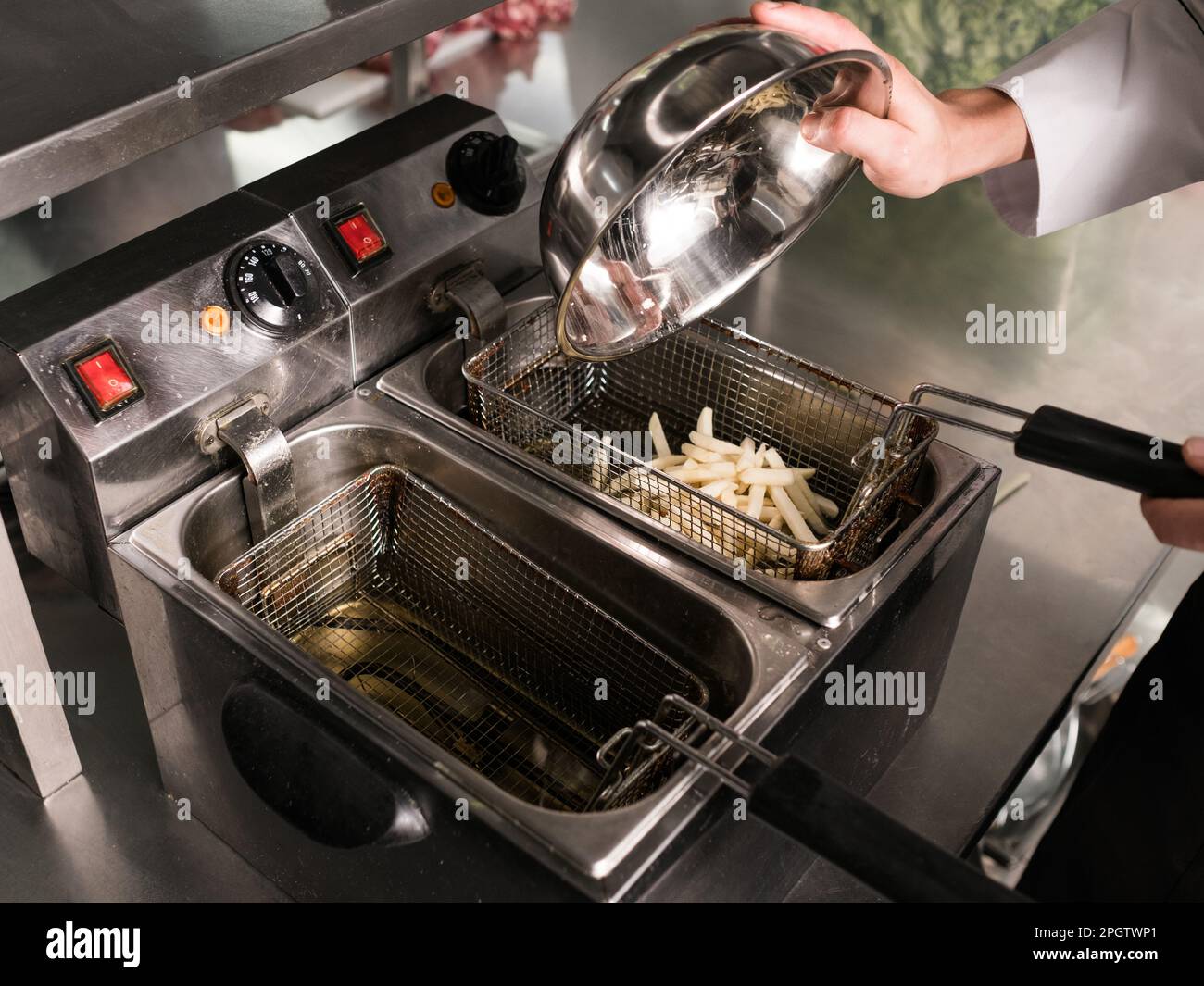 fast food preparing french fries unhealthy eating Stock Photo - Alamy