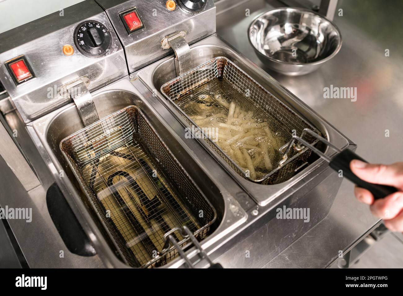 fast food preparing french fries unhealthy eating Stock Photo - Alamy