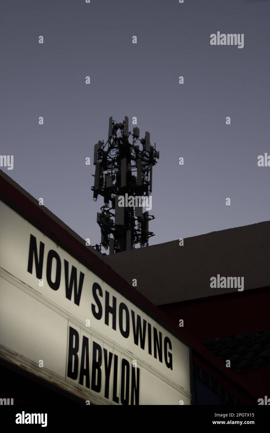An outdoor sign for a radio tower, featuring the words "Now Showing ...