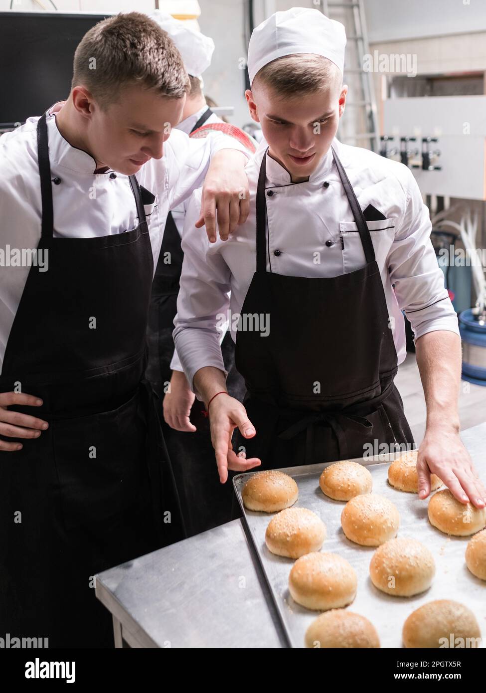 burger rolls quality check communication teamwork Stock Photo - Alamy