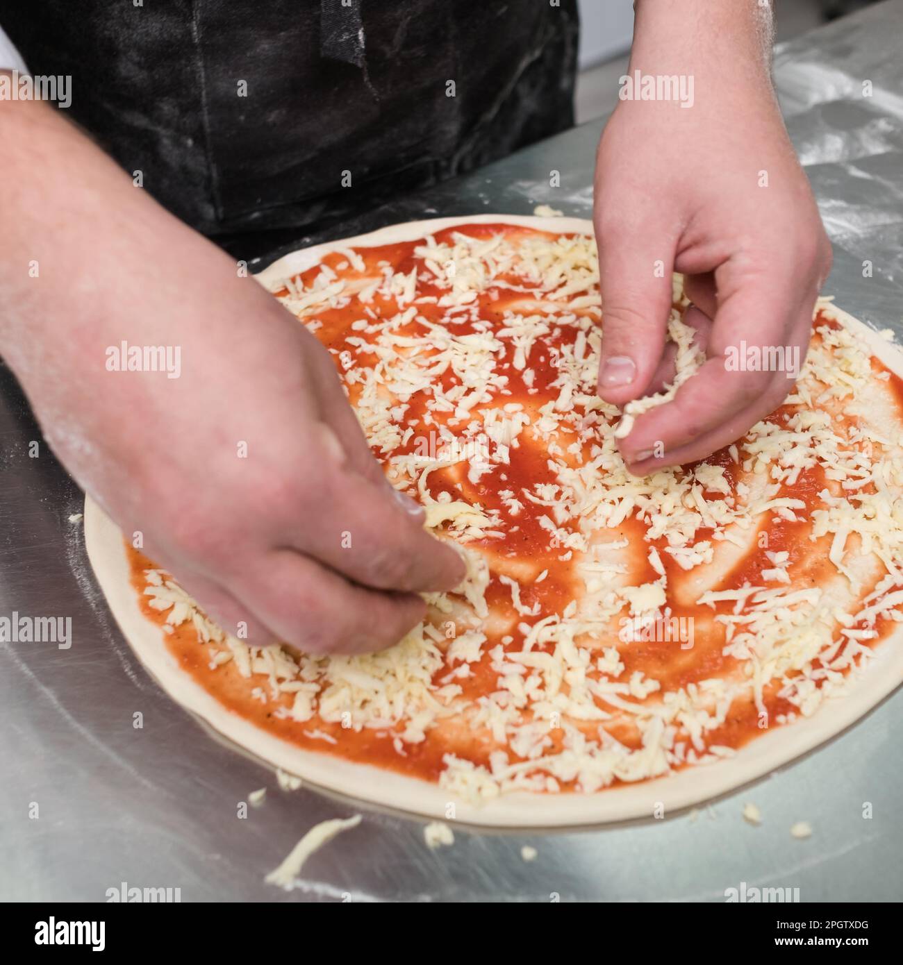 pizza cooking add cheese delicious meal Stock Photo - Alamy