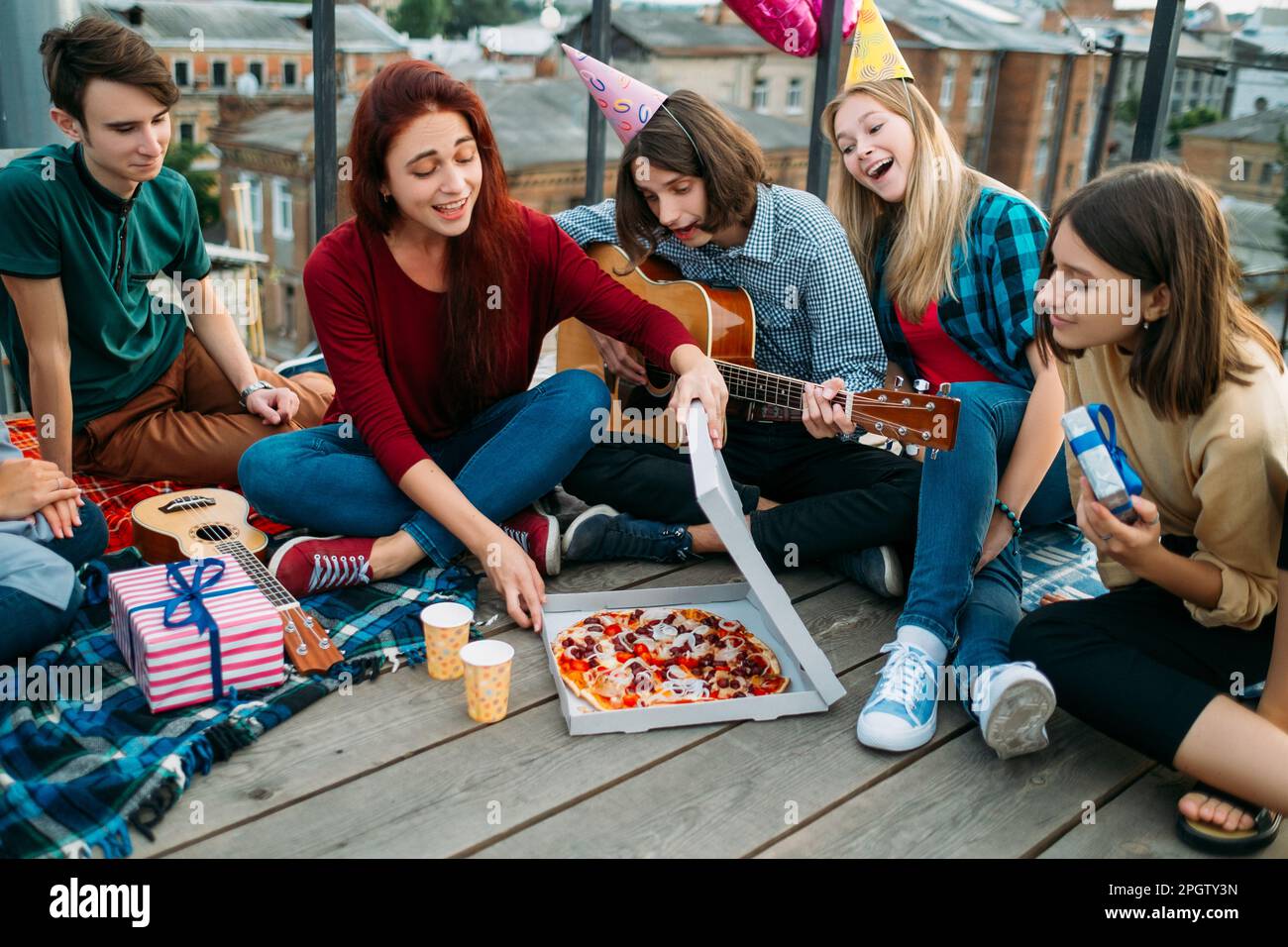 pizza delivery delicious food hungry teens Stock Photo - Alamy