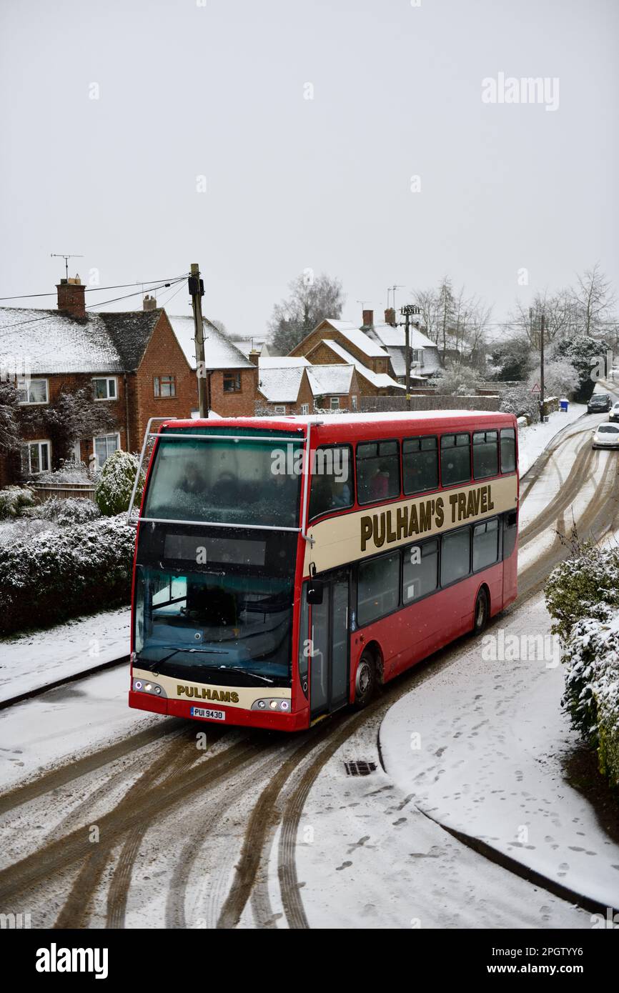 School Bus travelling in Hook Norton collecting School Children Stock ...