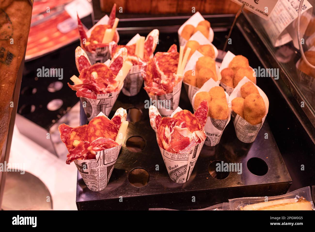 Traditional Spanish meat snacks, for sale in the La Boqueria market in ...