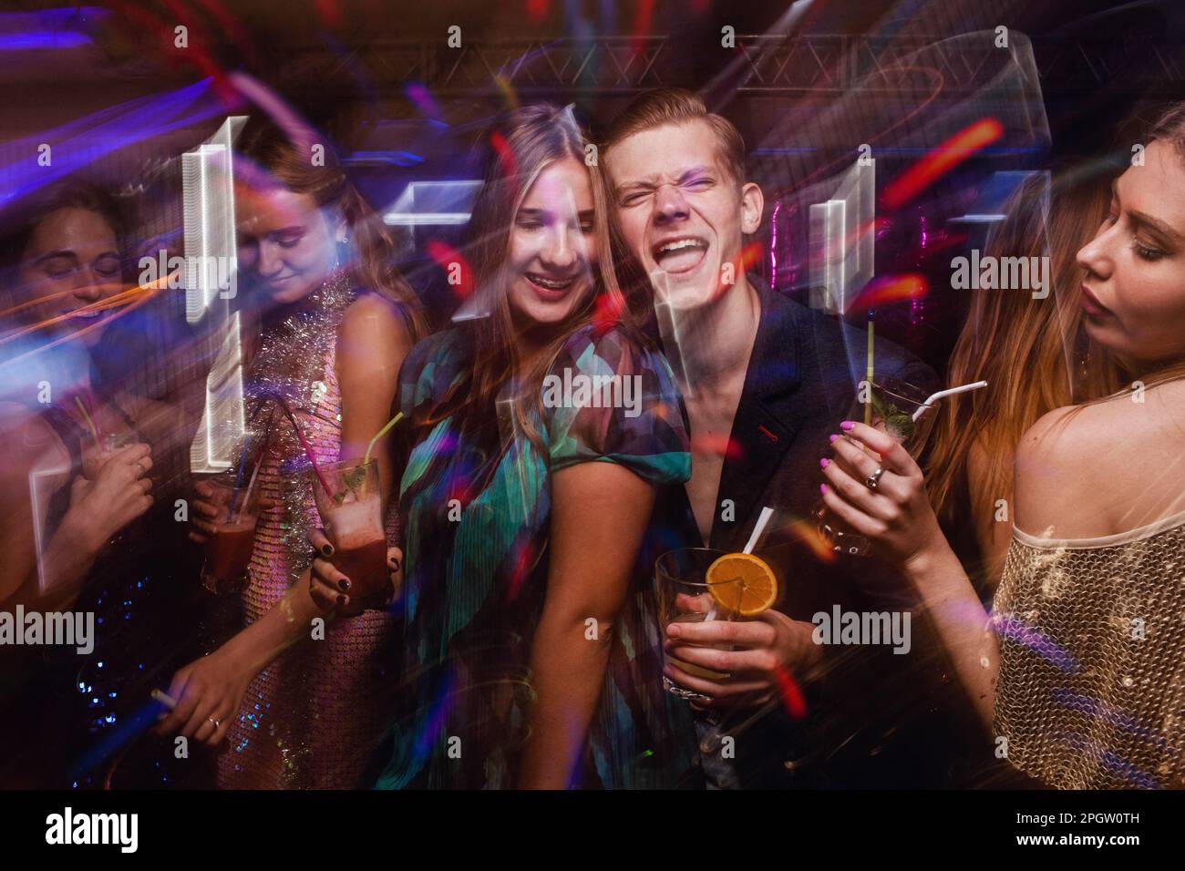 Happy company dancing in motion Stock Photo - Alamy