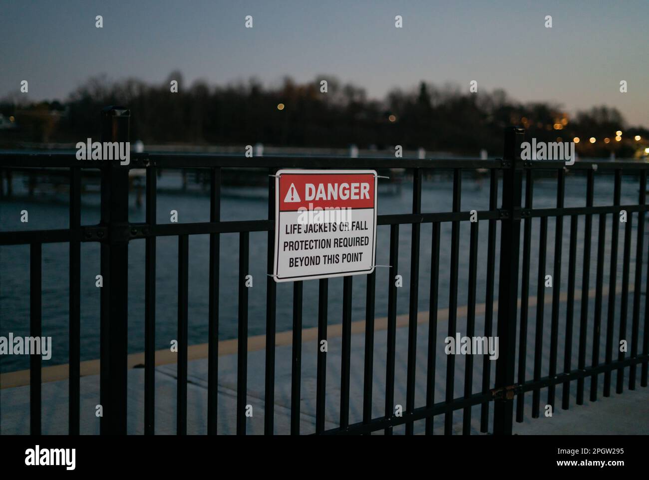 A fence with a sign warning about a danger outdoors Stock Photo - Alamy