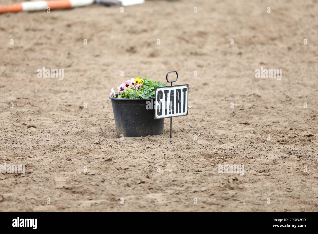 Start sign in the sand on show jumping race track at equestrian centre ...