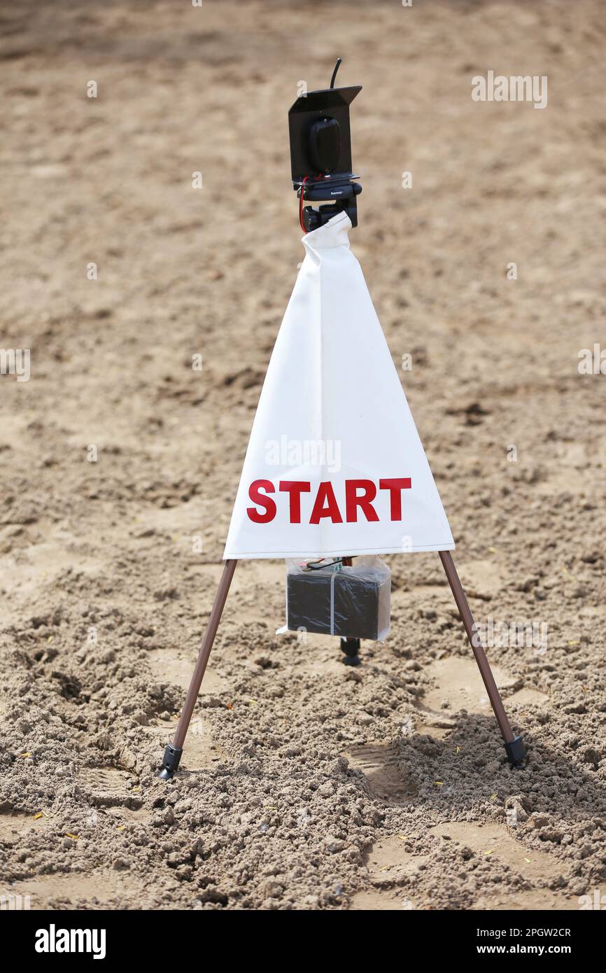 Start sign in the sand on show jumping race track at equestrian centre ...