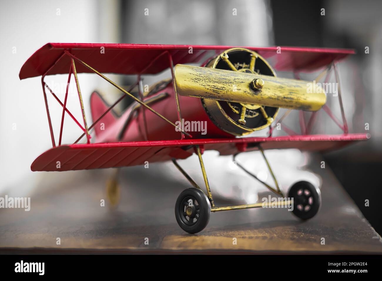 A small-scale model of a red airplane with golden accents and detailing ... A small-scale model of a red airplane with golden accents and detailing ...